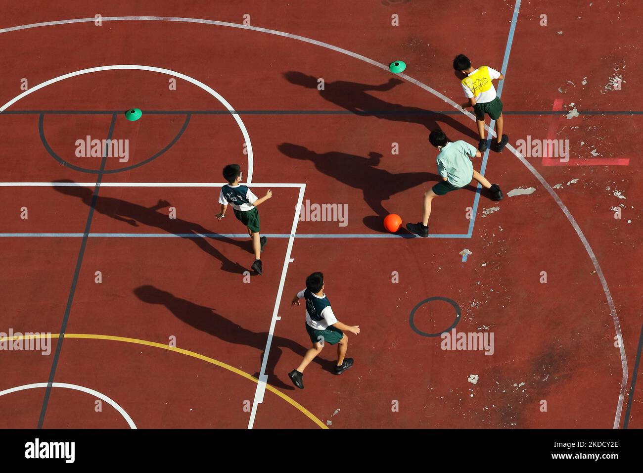 Students play ball during an extracurricular activity in school on June ...
