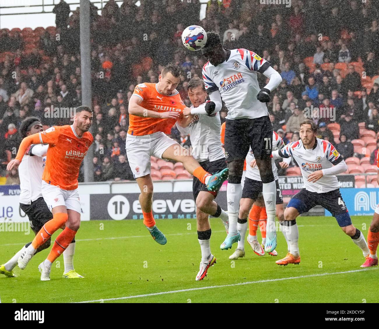 Elijah Adebayo #11 of Luton Town heads clear under pressure from Callum ...
