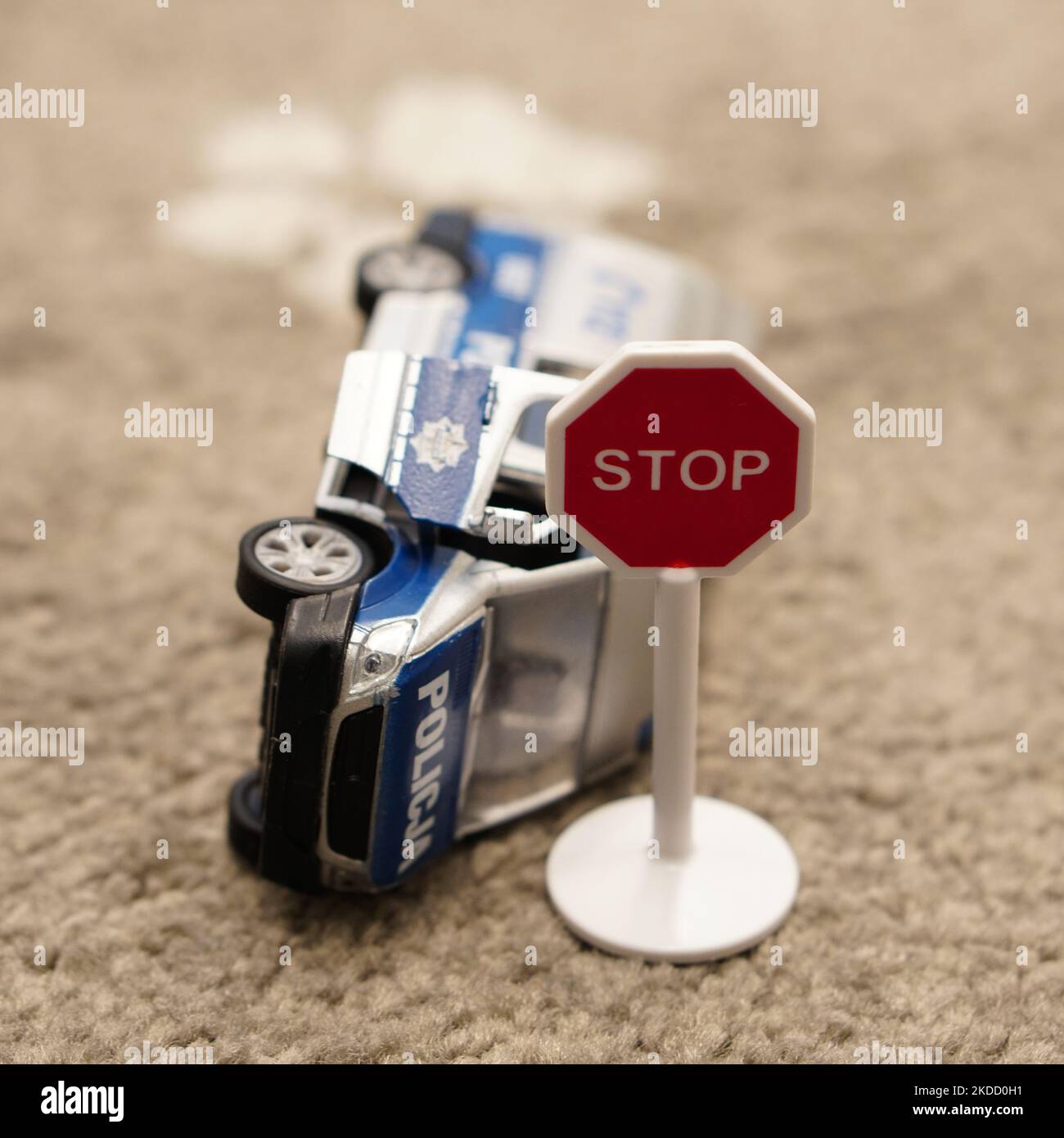 A closeup of a flipped toy police car with "stop" sign Stock Photo - Alamy