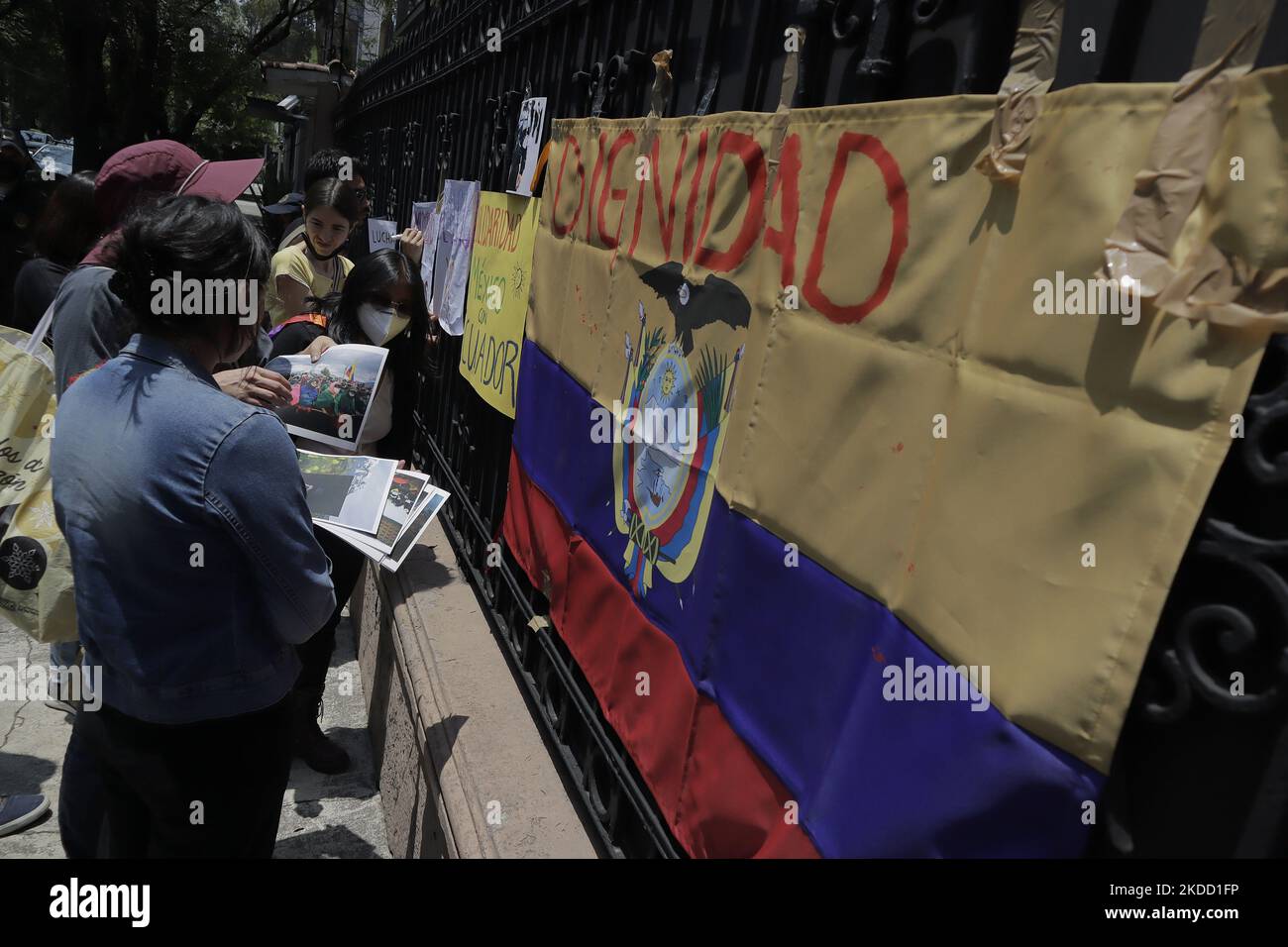 A group of people put up banners while demonstrating outside the ...