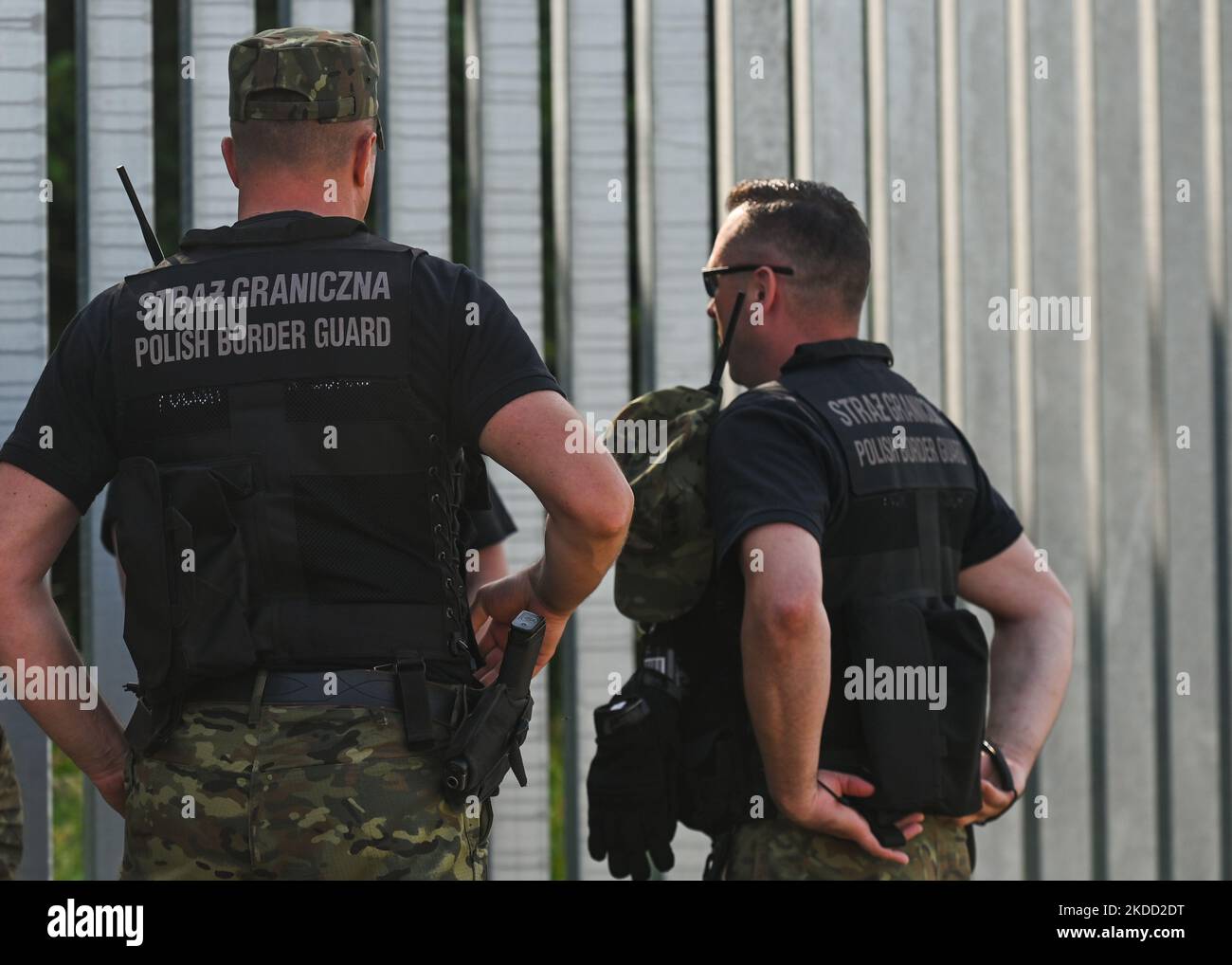 Polish border guards near the new fence on the Polish-Belarusian border ...