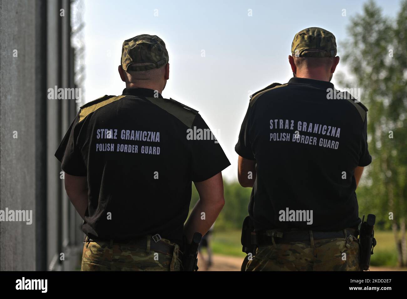Polish border guards near the new fence on the Polish-Belarusian border ...