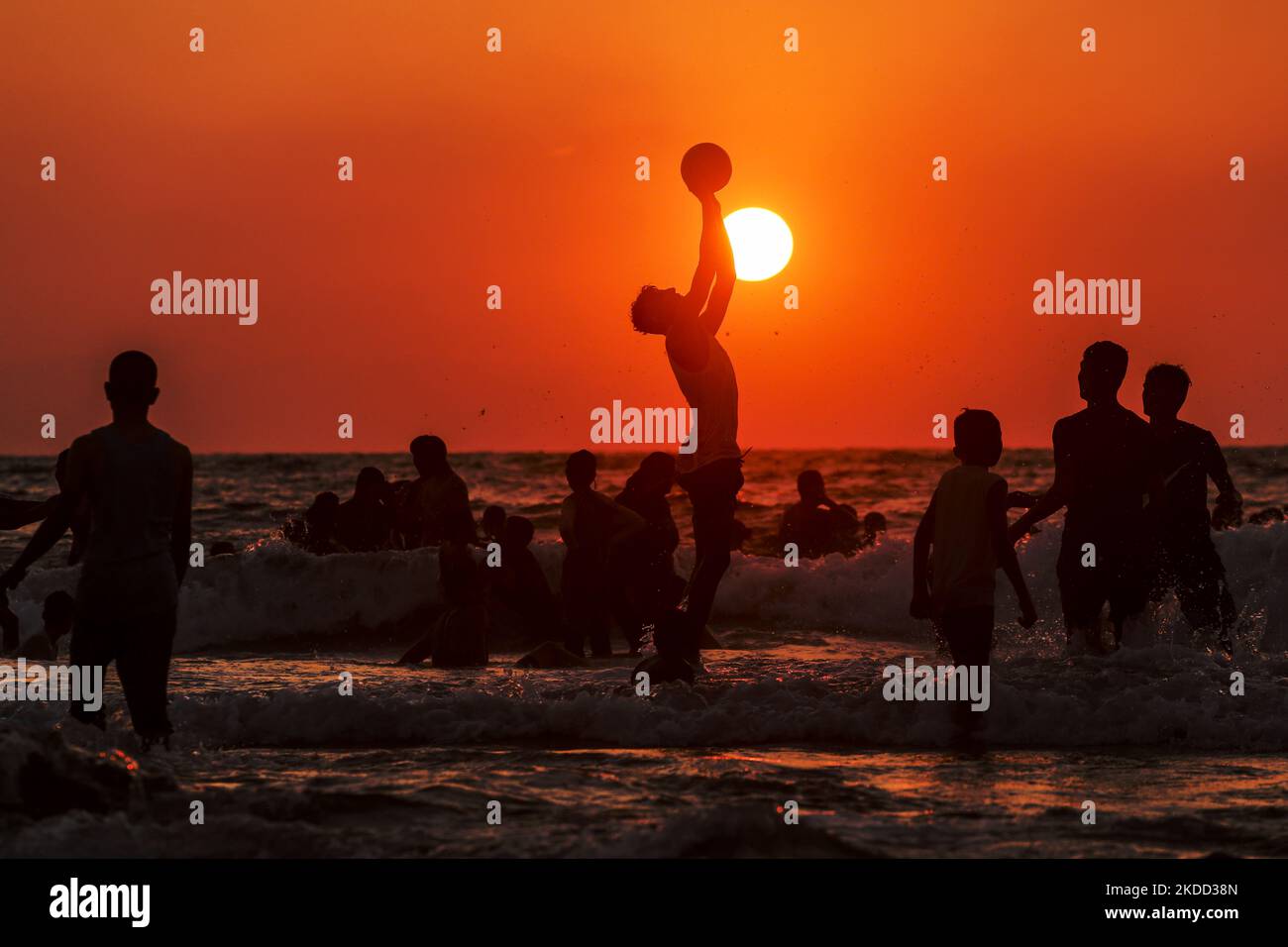 Palestinians swim and play with ball in Gaza Beach on a hot day and ...