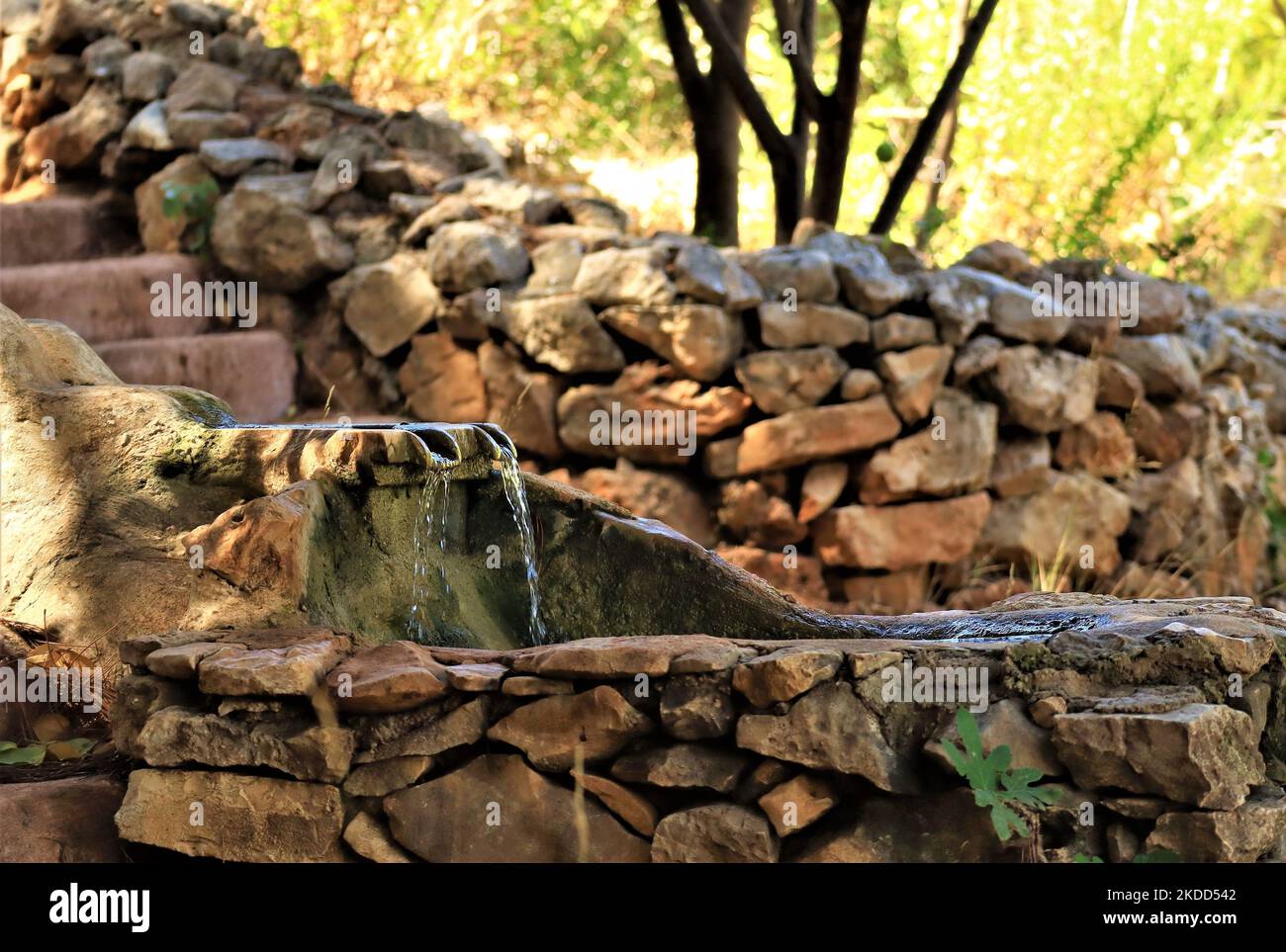 The stones shaping the channel for water to flow down the hill in the ...