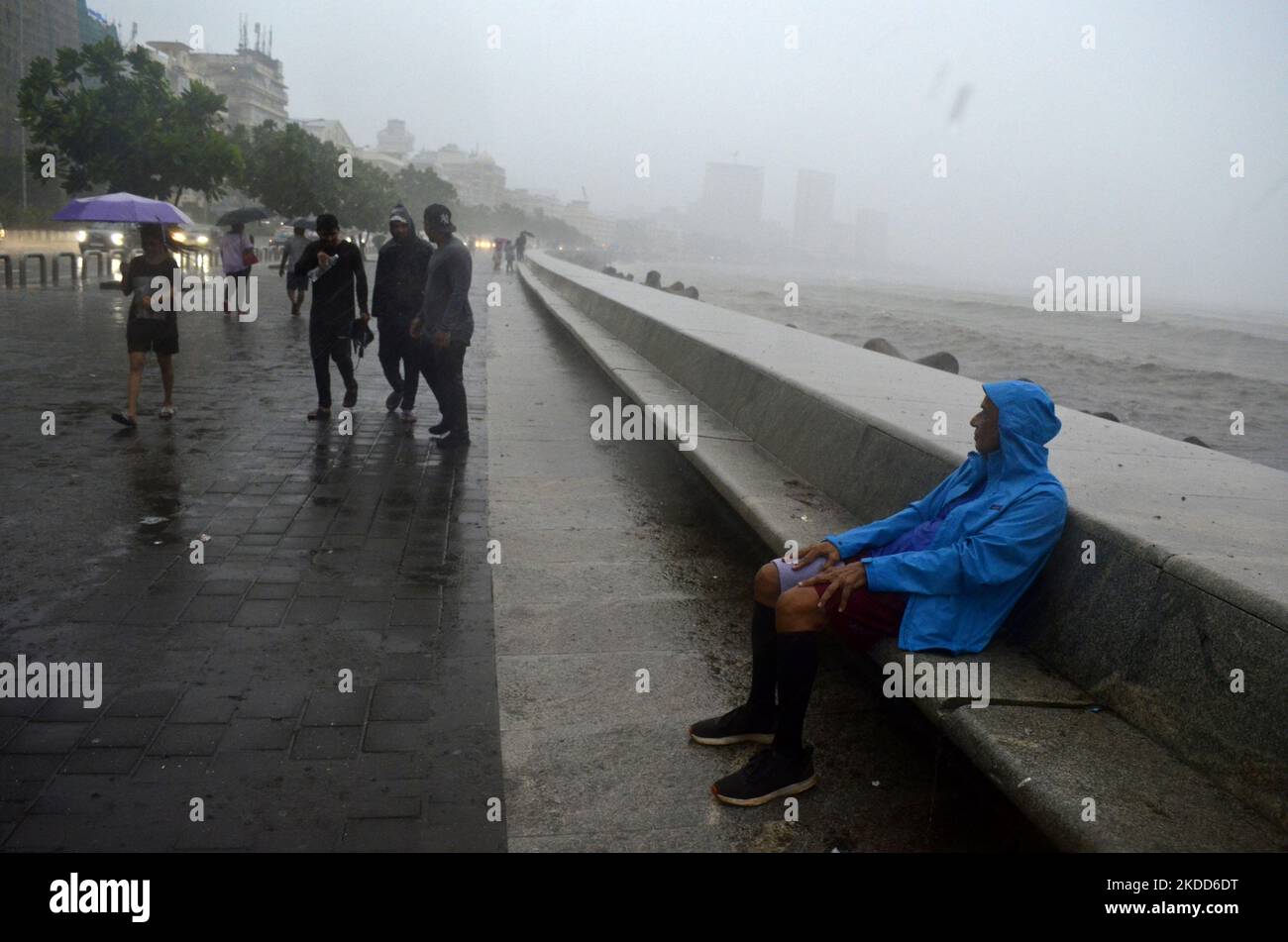 An old man enjoys heavy rainfall in Marine drive, Mumbai, India, 04 ...