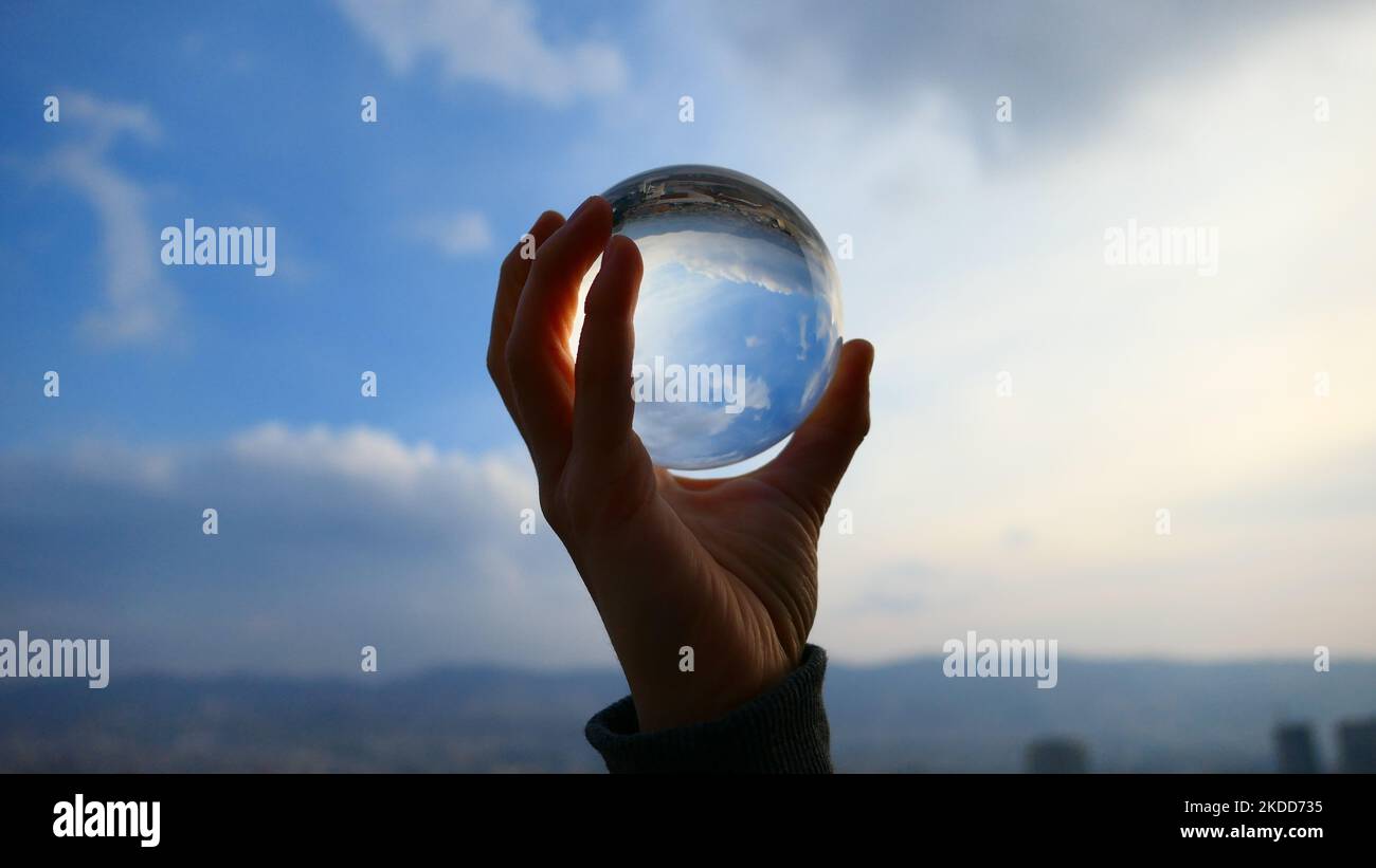 A person holding a crystal ball Stock Photo - Alamy