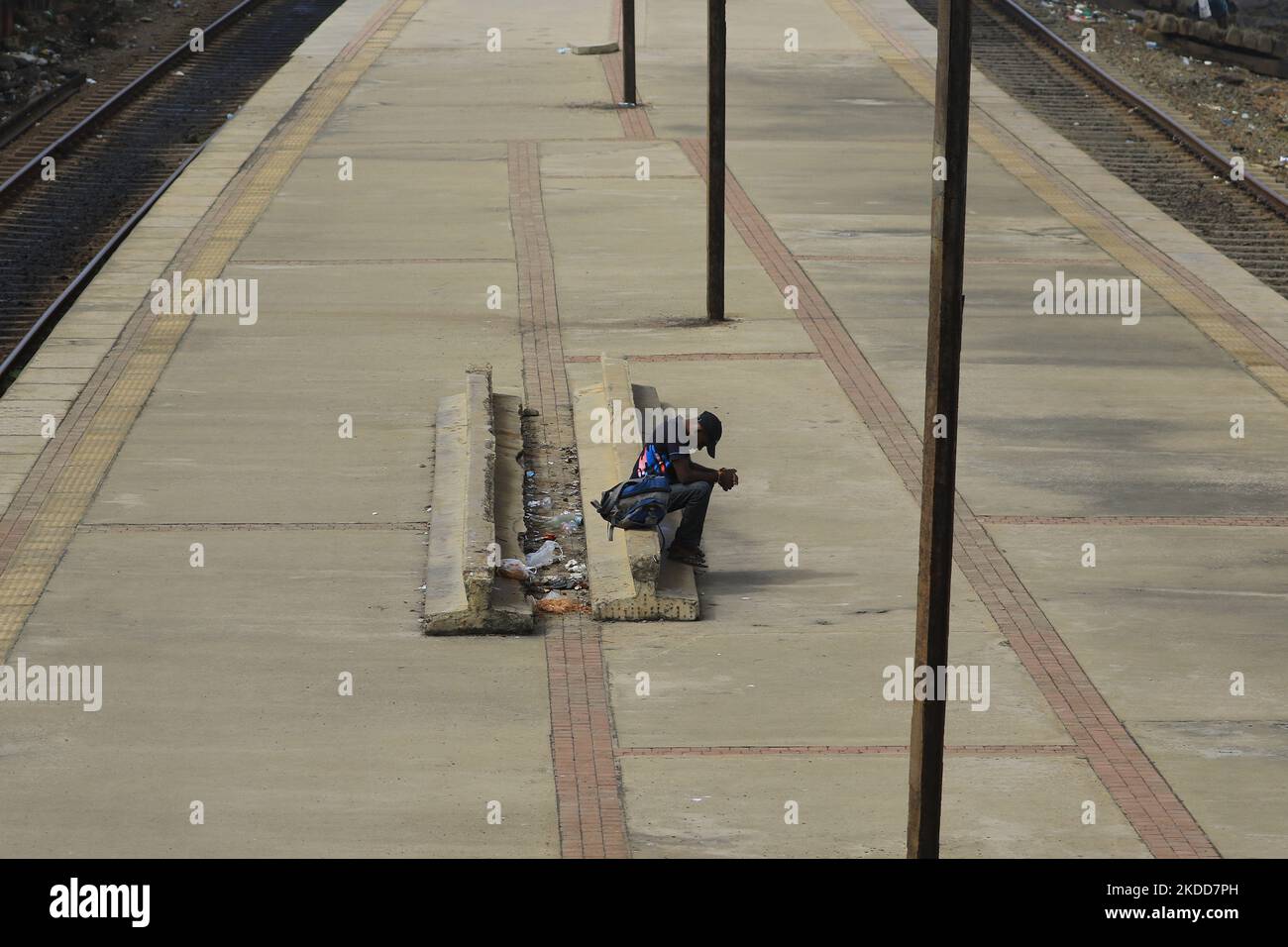 A Sri Lankan commuter waits for a train in a railway station at Colombo ...