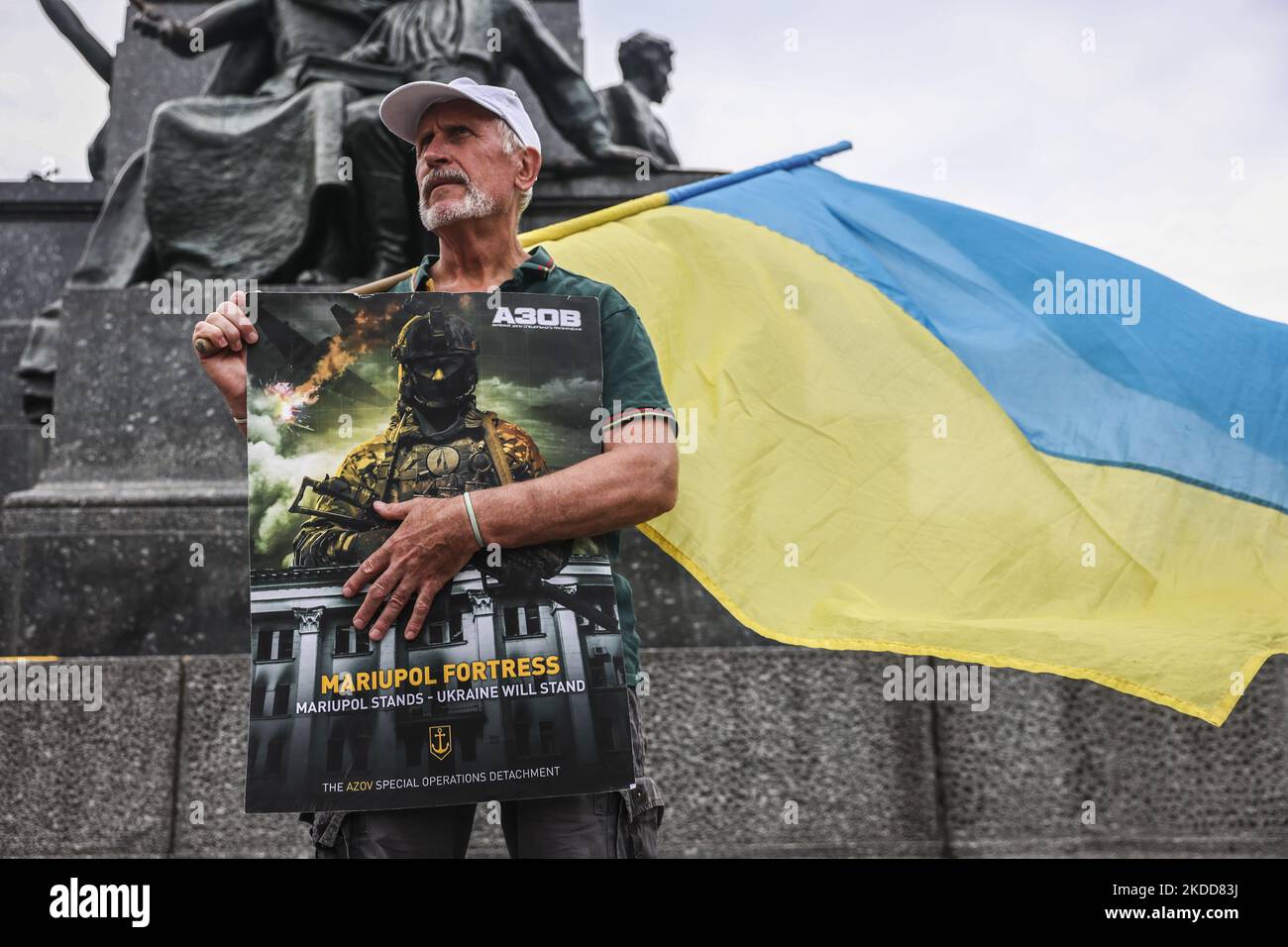 A man hold Ukrainian flag and a banner during a demonstration of ...