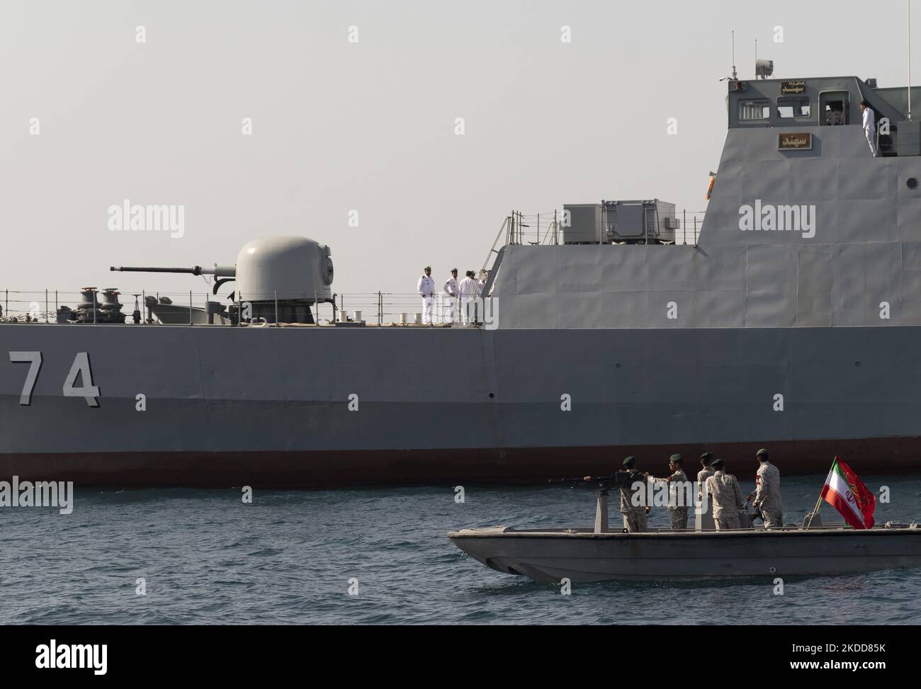 Iranian Navy soldiers at an armed speed boat next to the Sahand Warship ...