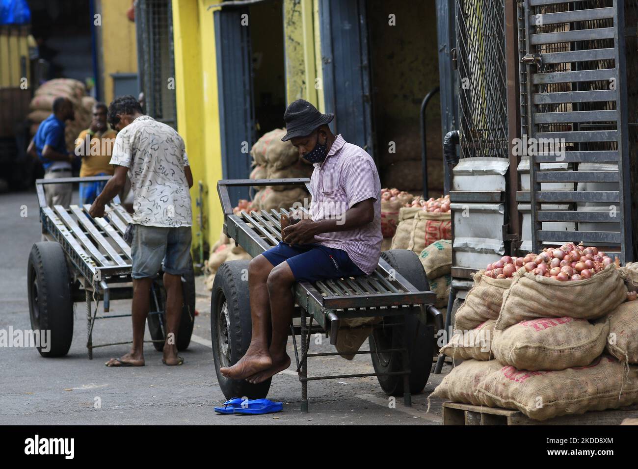 A Sri Lankan daily wage worker checks his wallet after finishing work ...