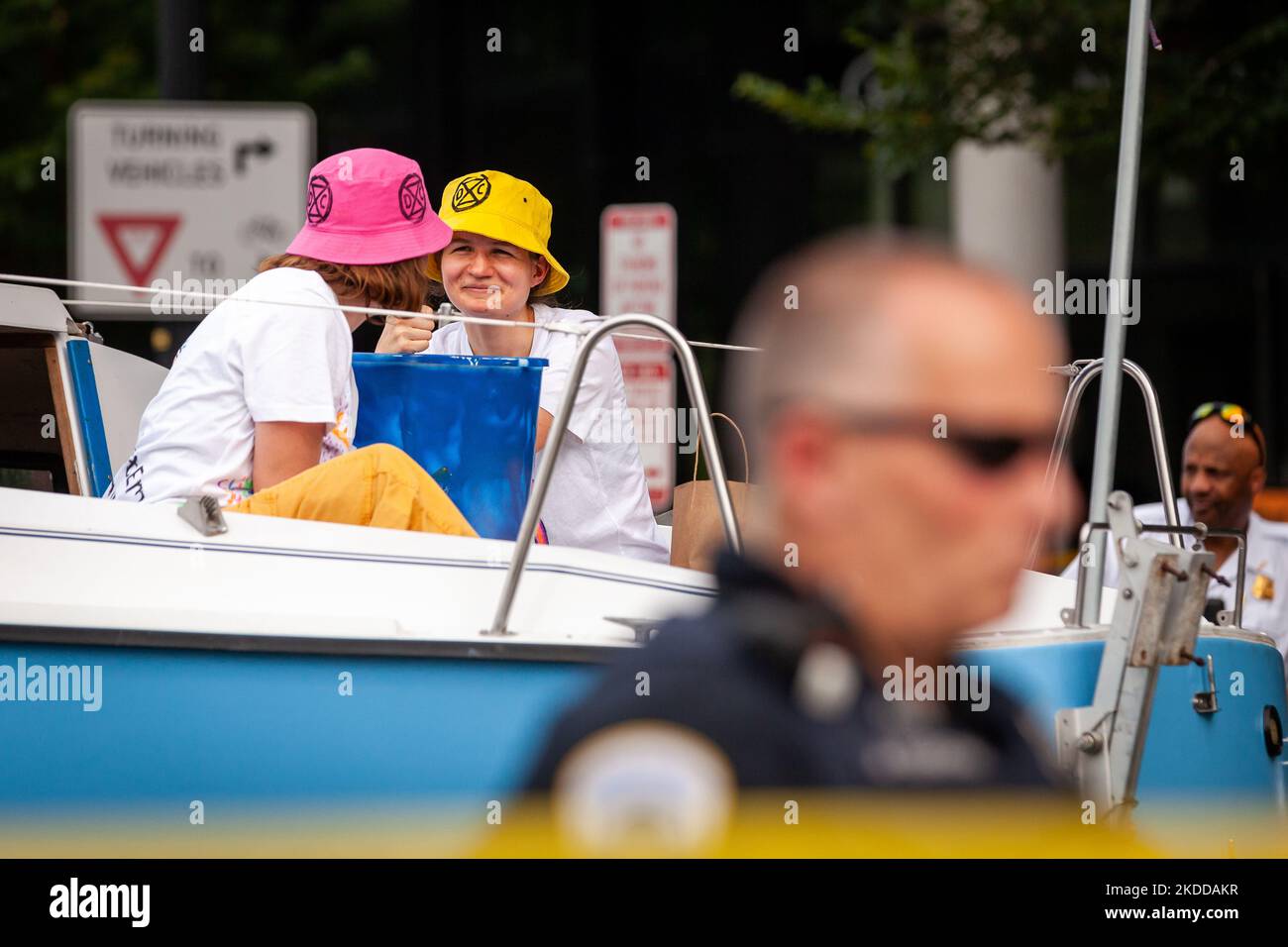 Two members of Extinction Rebellion DC occupy a boat blocking traffic ...