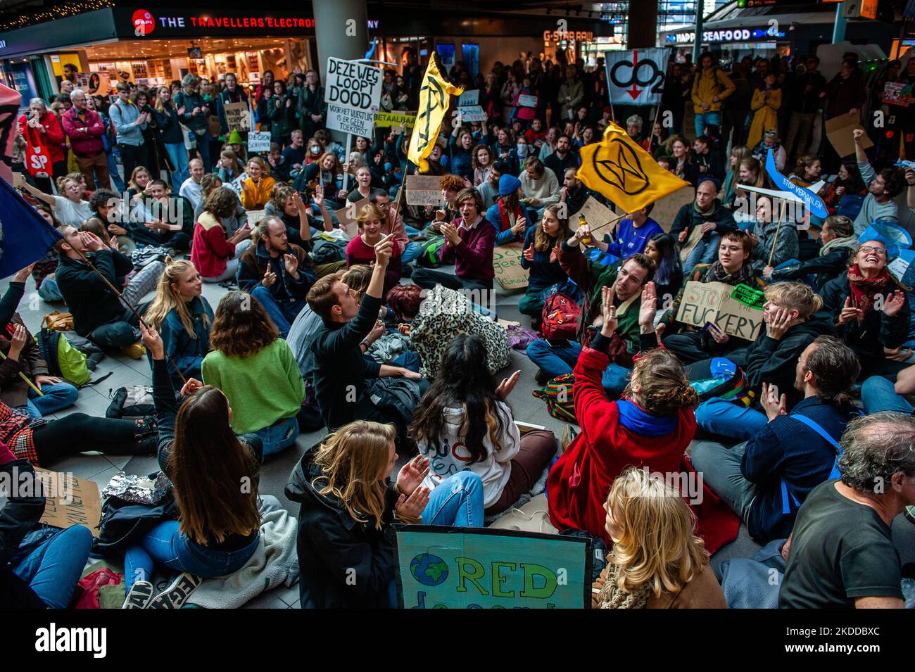 Climate activists are seen sitting on the ground of the main hall of ...