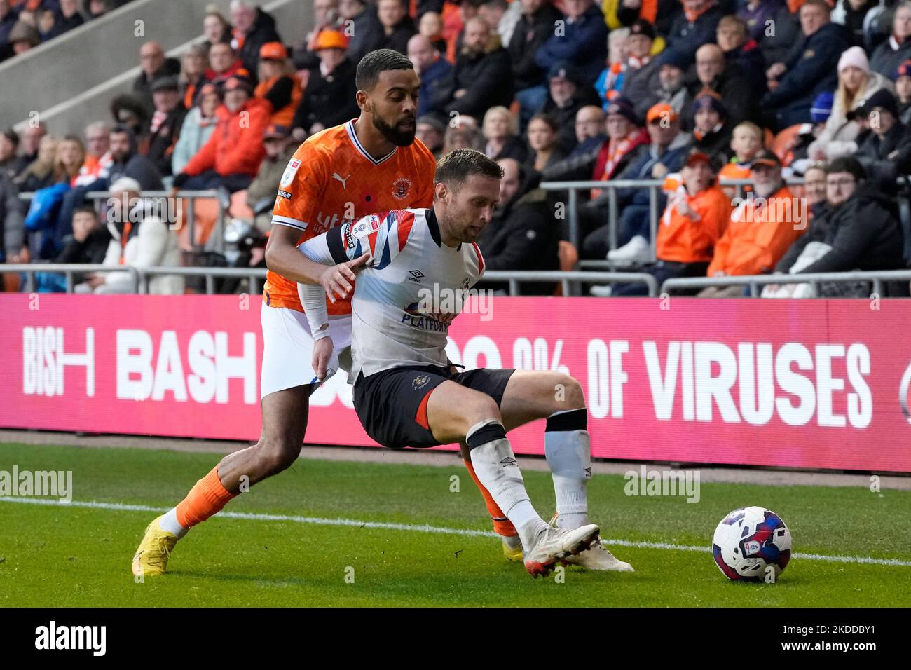 Jordan Clark #18 of Luton Town holds off CJ Hamilton #22 of ...