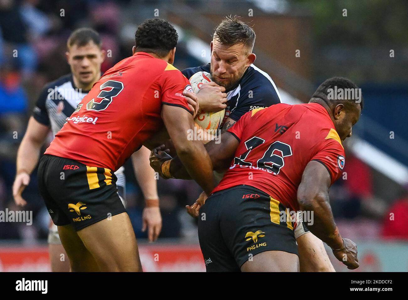 Mike Cooper of England is tackled by Mckenzie Yei and Jacob Alick of ...
