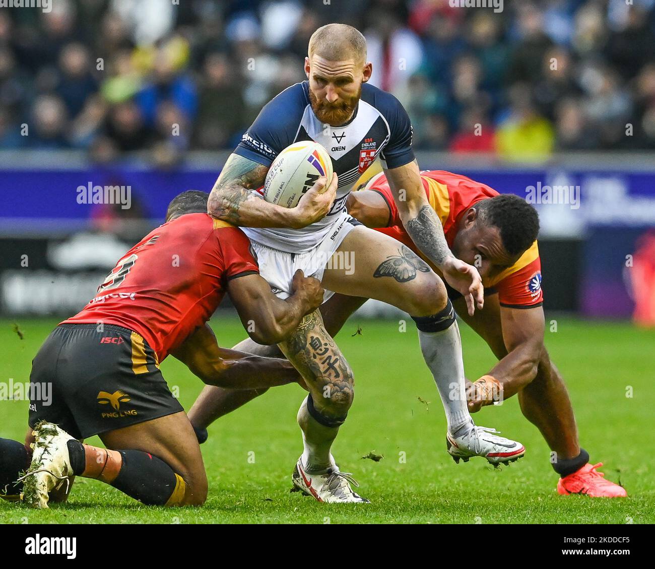 Sam Tomkins of England is tackled by Edwin Ipape and Wesser Tenza of ...
