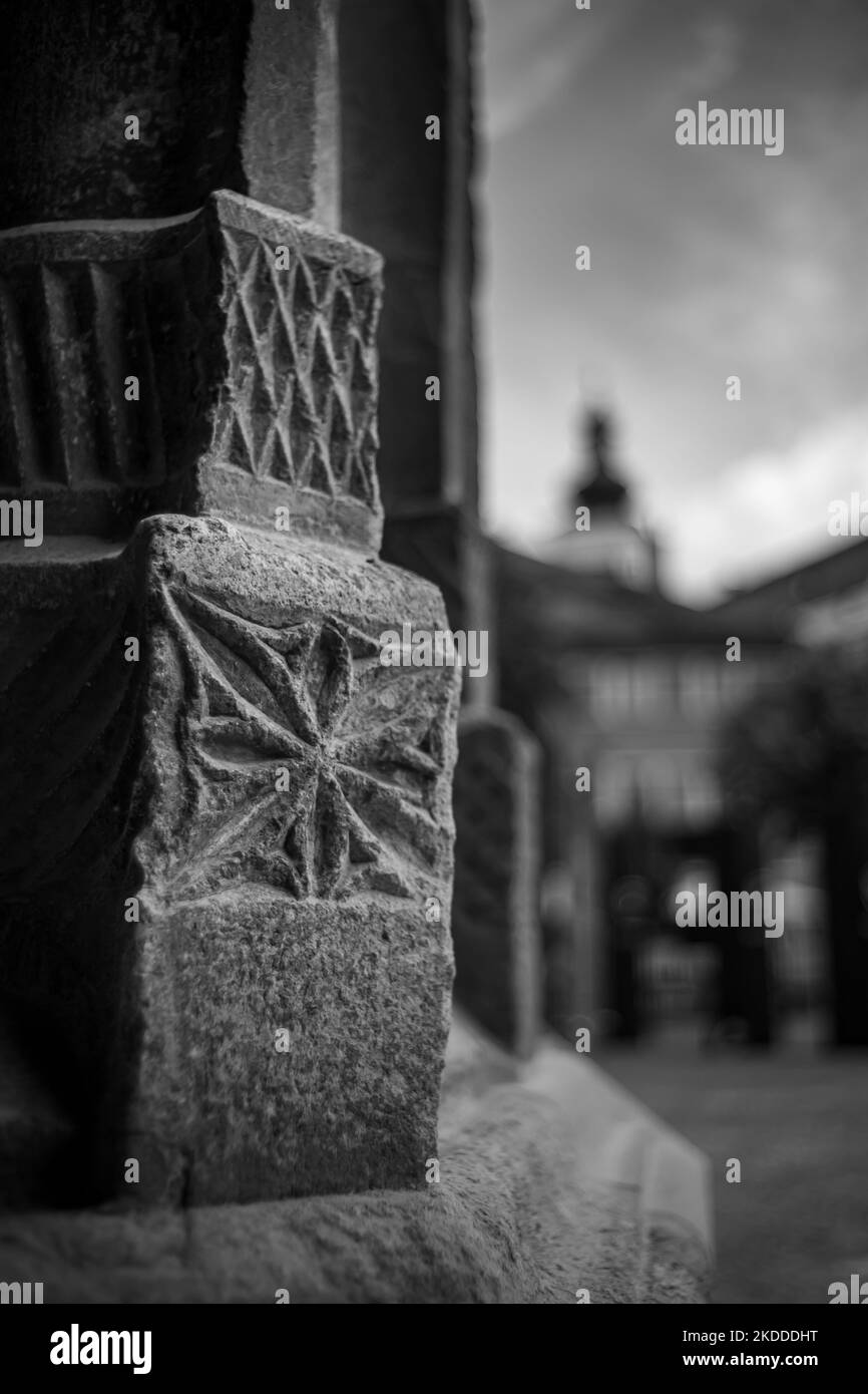 A vertical selective focus closeup grayscale of a detailed stone column ...