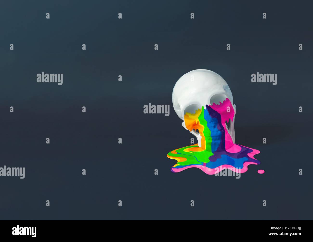 A skull with vivid paint which is dripping, leaking and pouring on dark ...