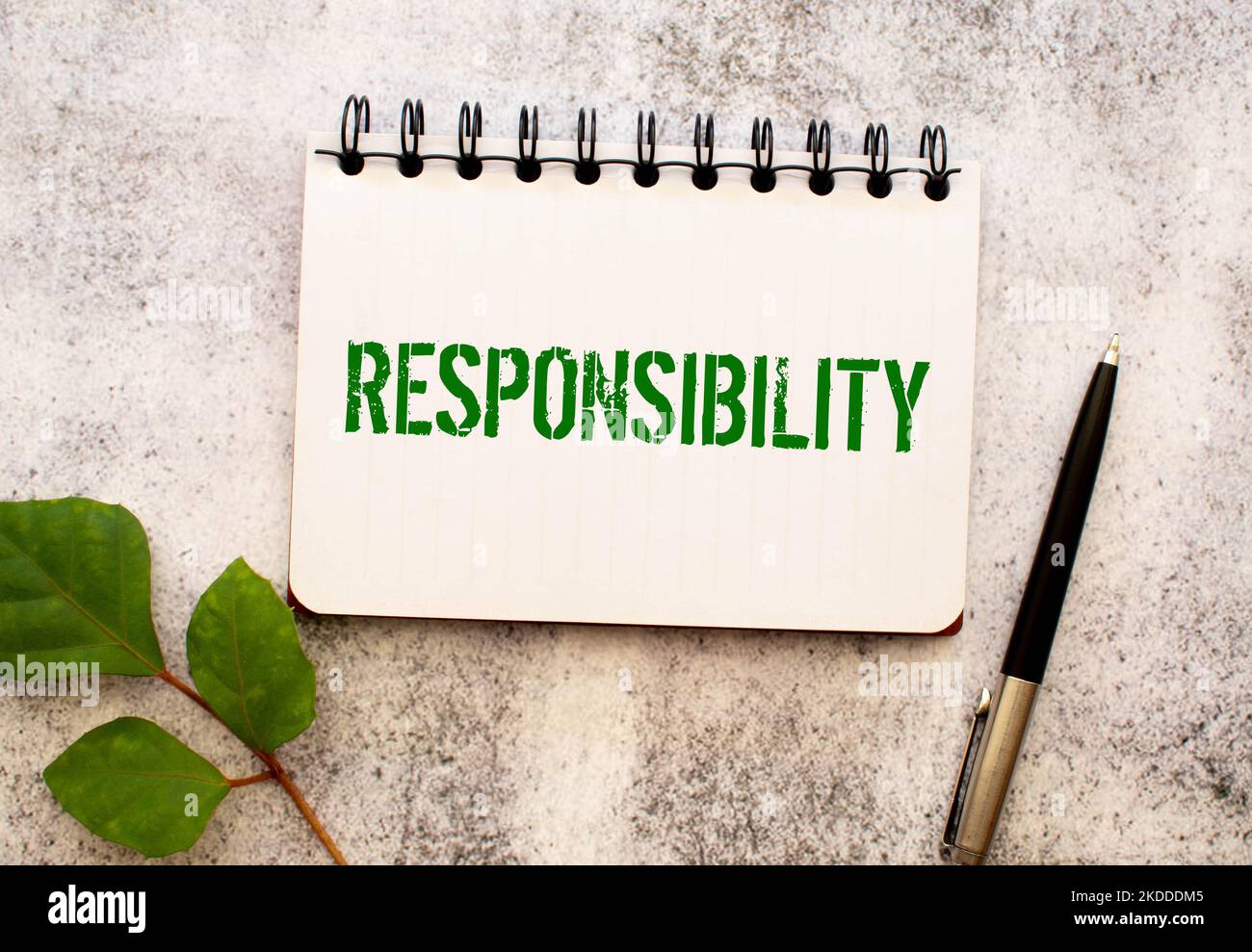 Three plasticine human figures holding card with word Responsibility on ...