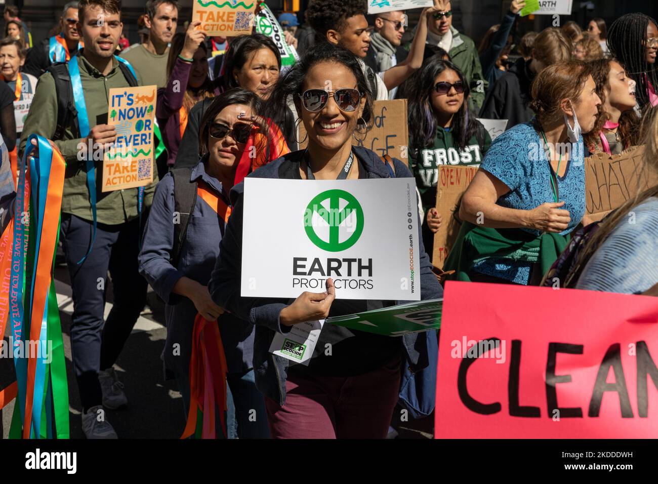 A shot of activists with posters and cardboard signs marching to ...