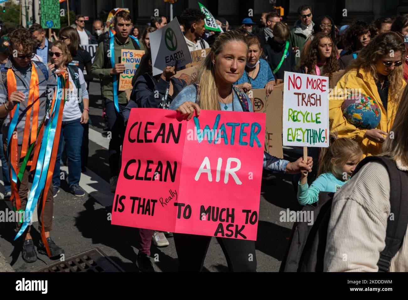 A shot of activists with posters and cardboard signs marching to ...