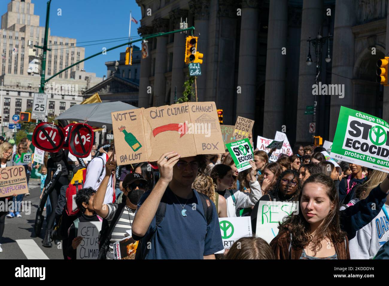 A shot of activists with posters and cardboard signs marching to ...