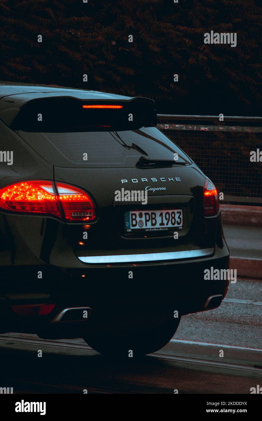 A vertical shot of the back of a black Porsche Cayenne car Stock Photo ...