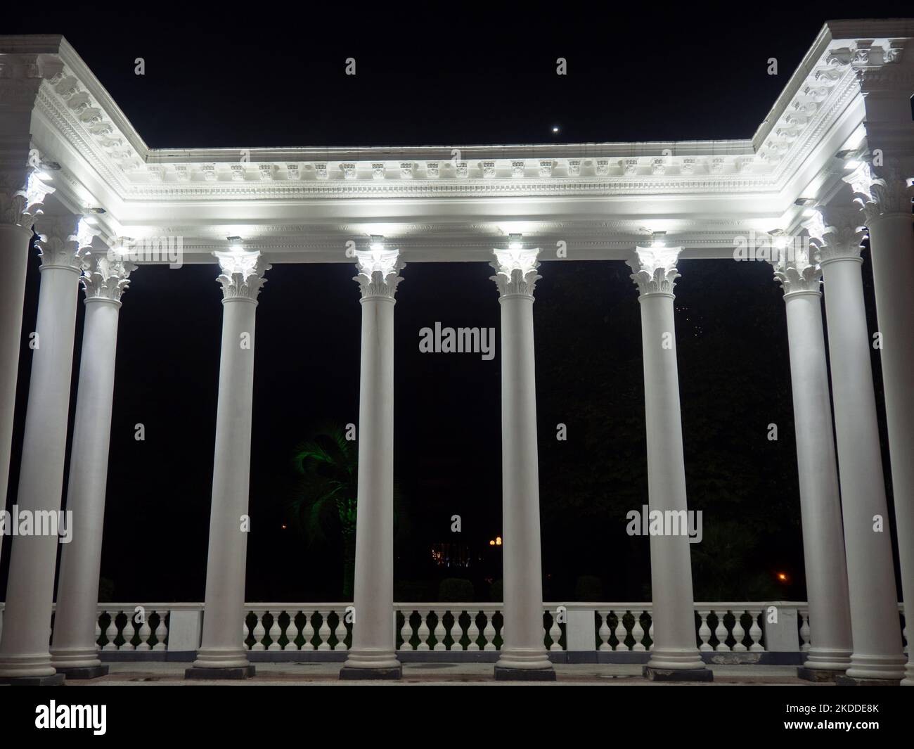 White colonnade in the dark. White columns in the light of spotlights ...