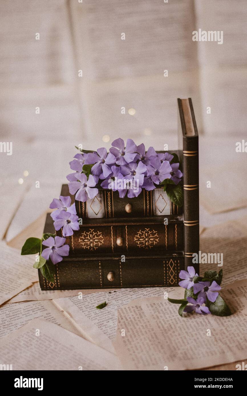 A vertical shot of an abandoned bouquet on vintage brown books Stock ...