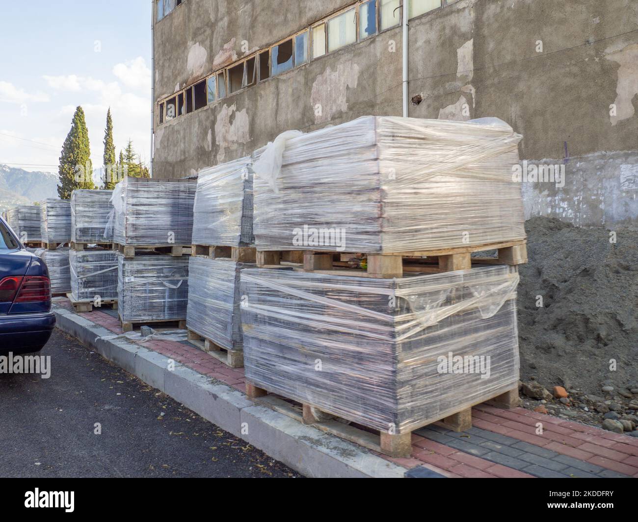 Pavement repair. Laying out paving stones. Paving stones in pallets in ...