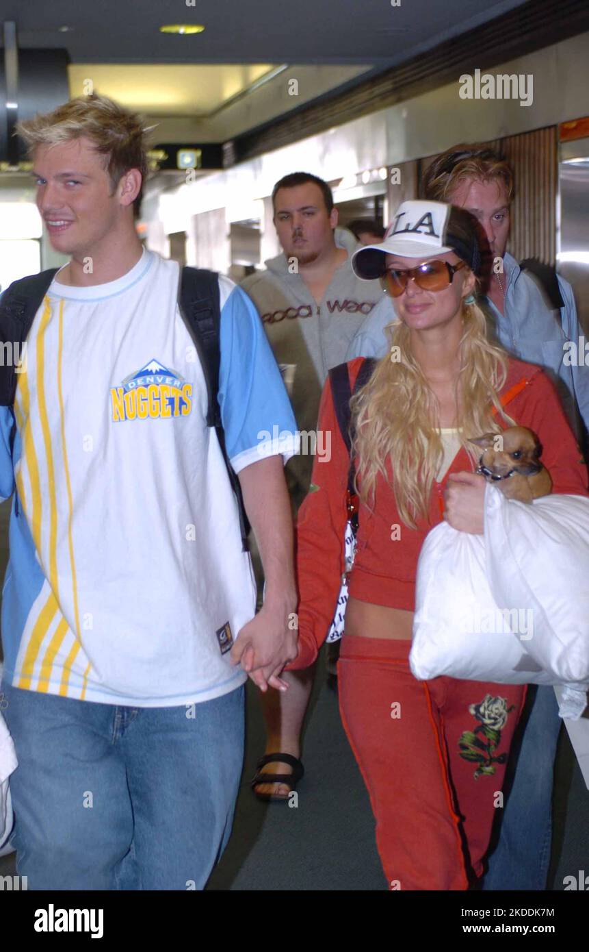 MIAMI, FL - 2004: Paris Hilton and her dog Tinker Bell along with ...