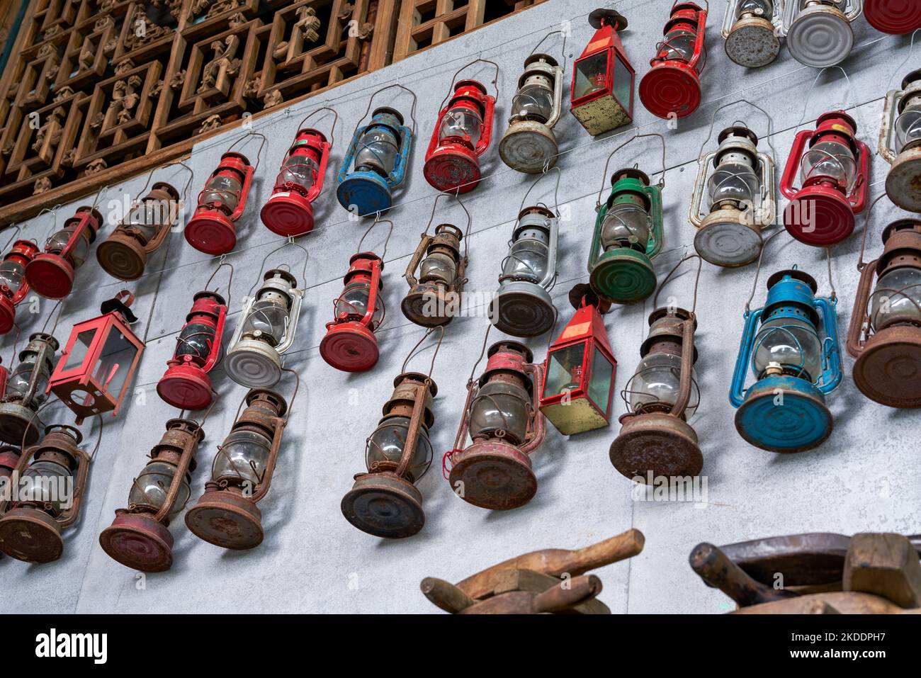 Vintage kerosene lamps hanging all over the wall for sale in a thrift ...