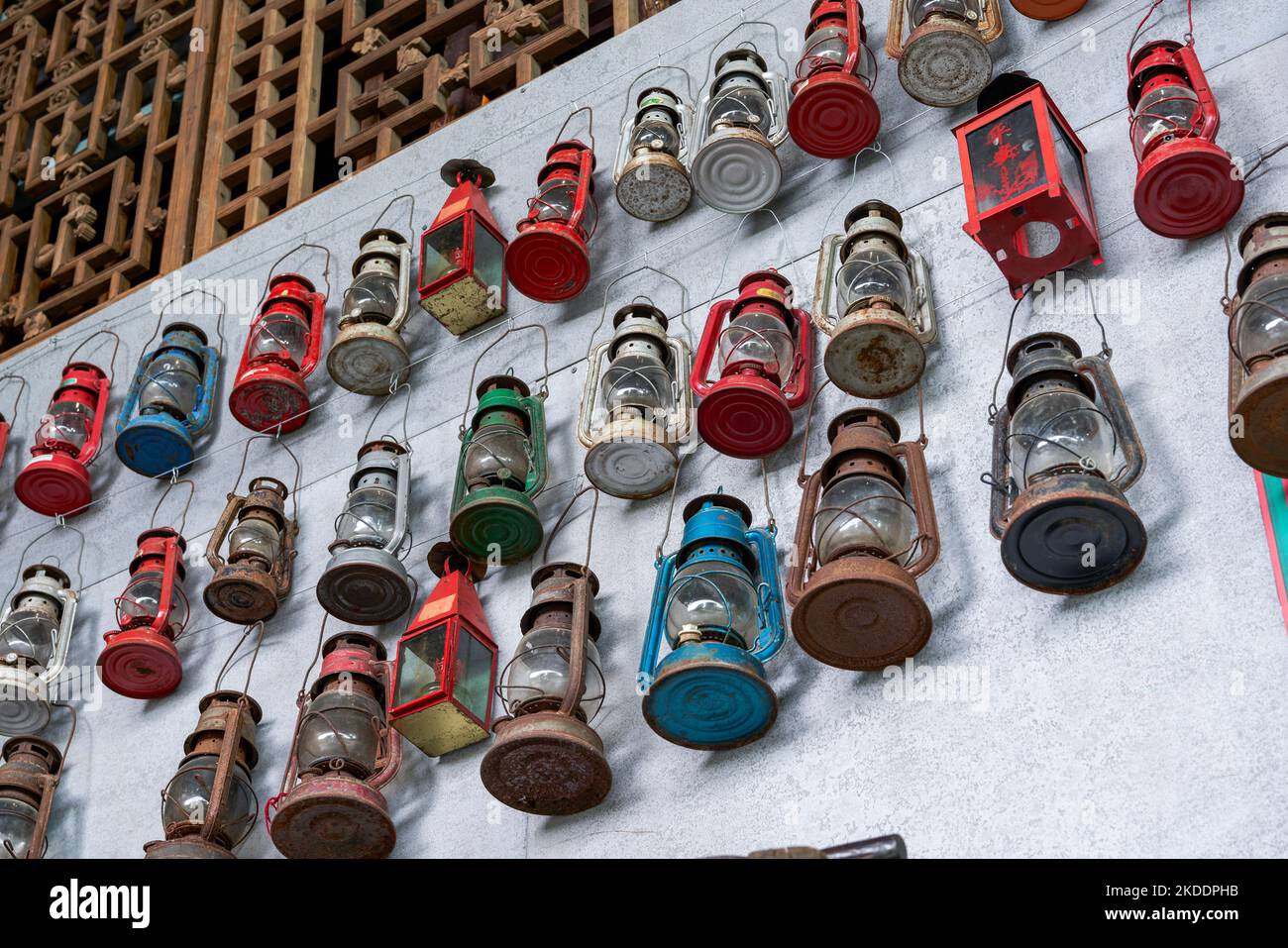 Vintage kerosene lamps hanging all over the wall for sale in a thrift ...