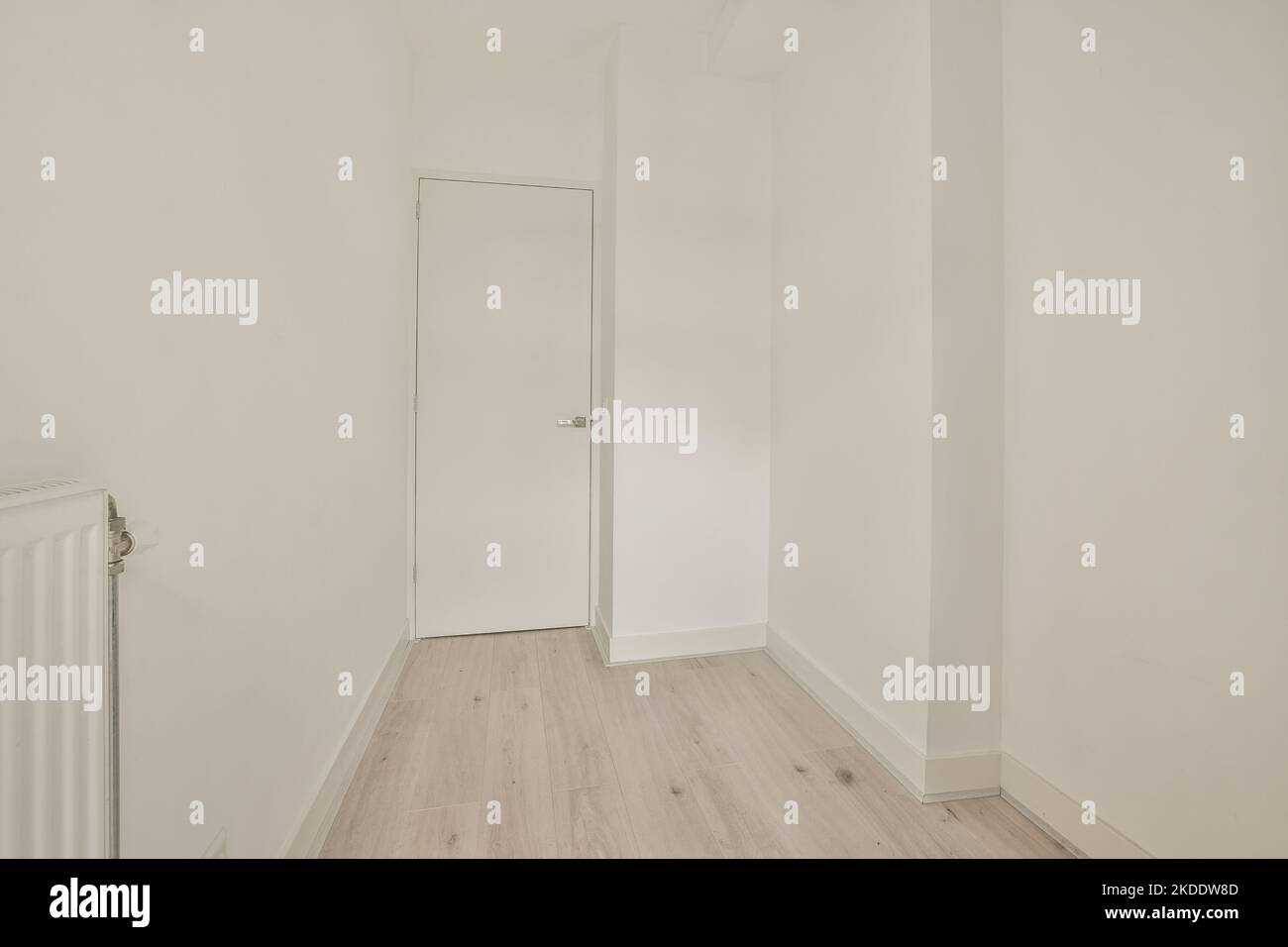 Plastic window and radiator on white wall in empty light room at home ...