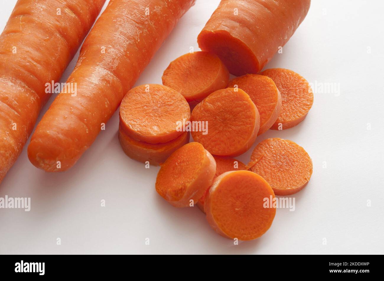 Cut carrot on white background. From above Stock Photo - Alamy