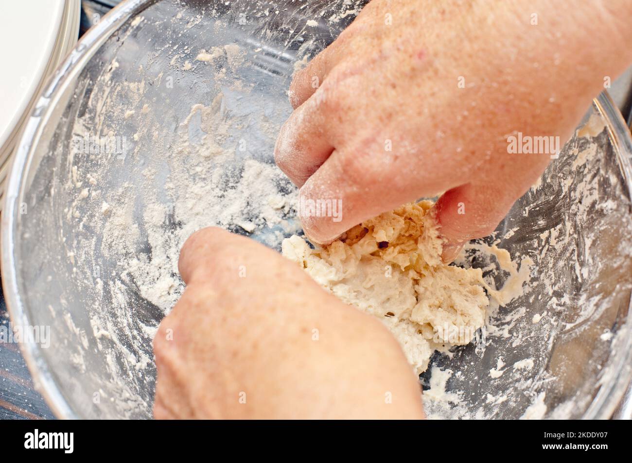 First person perspective top down view on pair of hands mashing up food ...