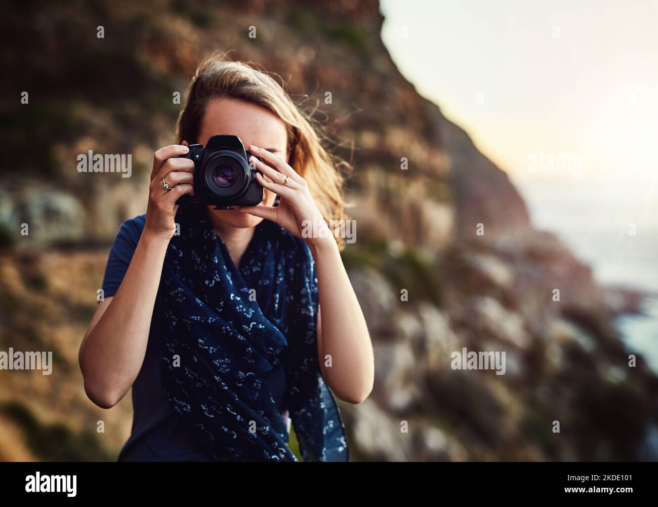 Capturing memories through a lens. Portrait of a young woman taking ...