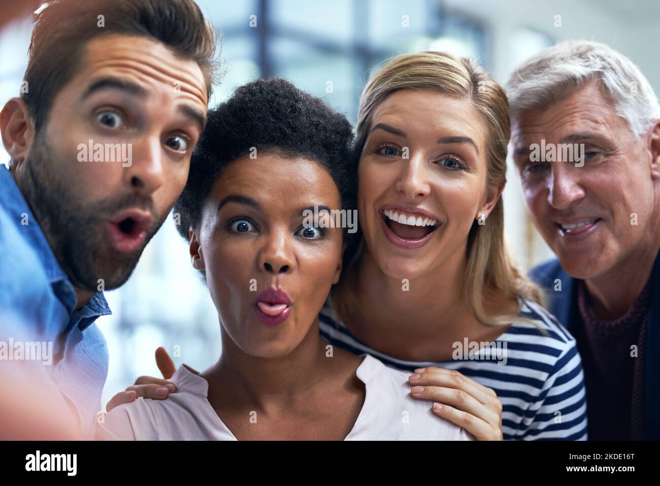 Team selfie silliness. a group of colleagues taking a fun selfie ...