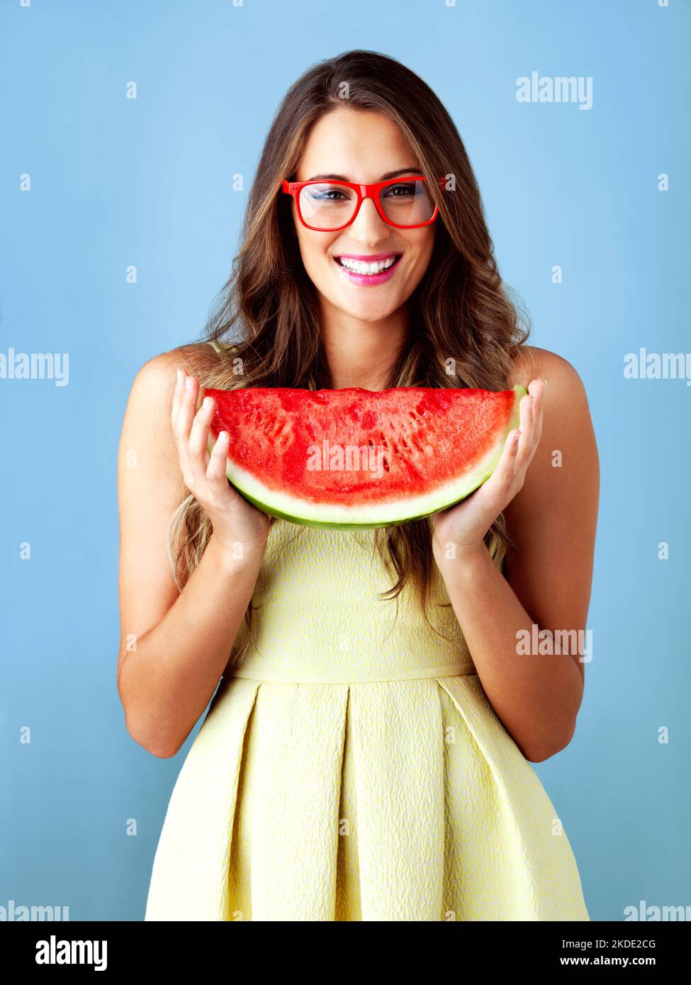 The most summery fruit ever. Studio shot of an attractive young woman ...