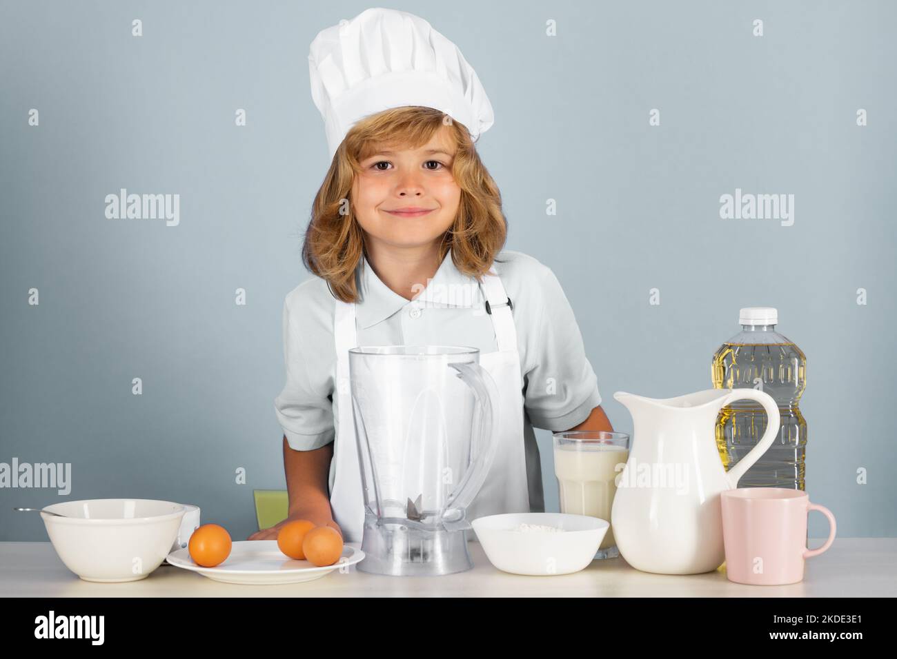 Cooking children. Chef kid boy making fresh vegetables for healthy eat ...