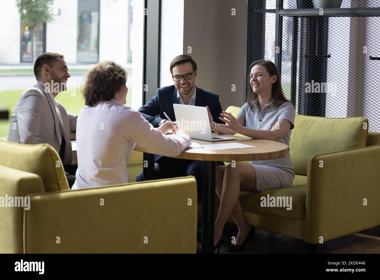 Group of cheerful office employees joking engaged in meeting Stock ...