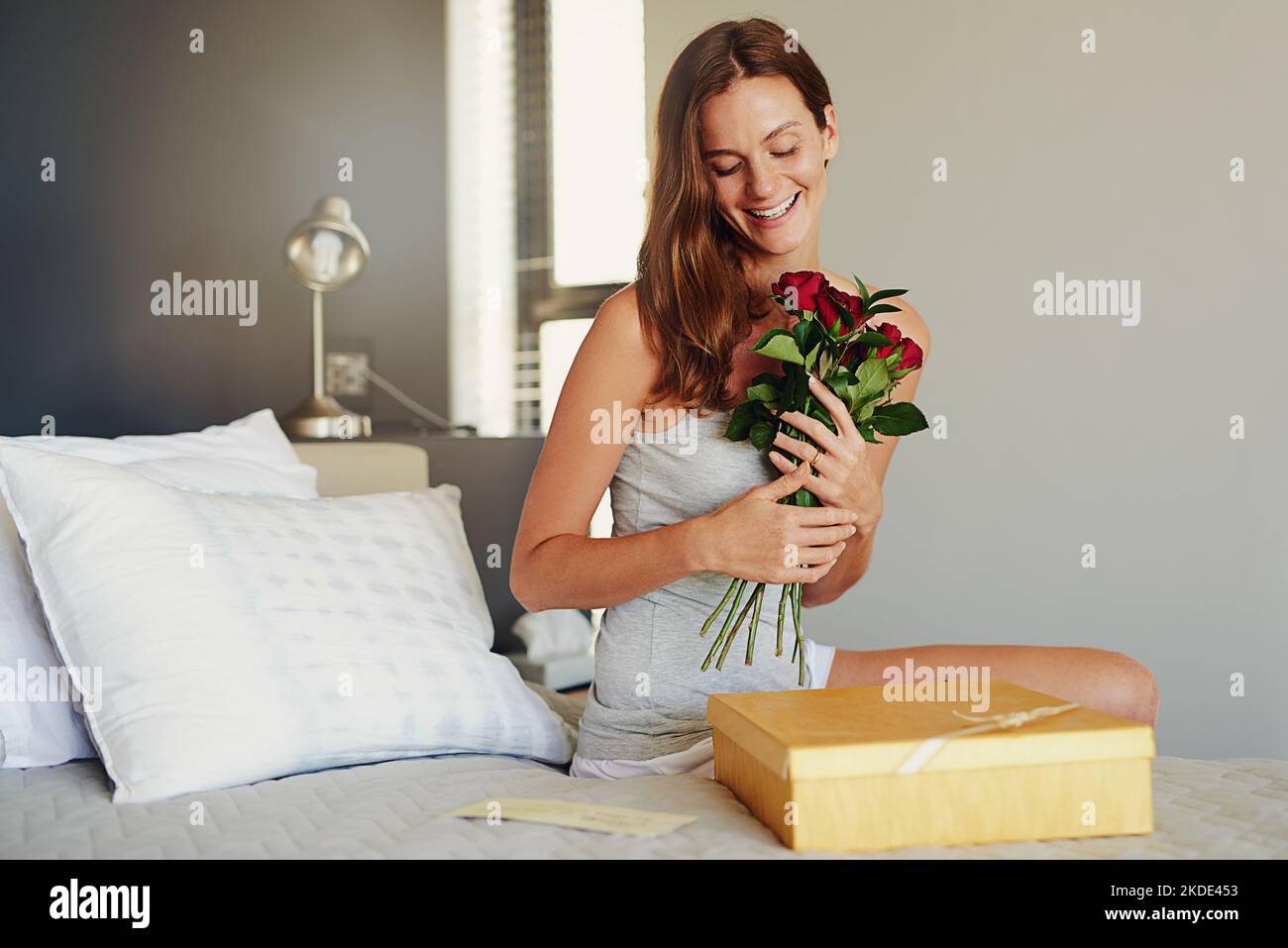 Her crush went the extra mile to make her smile. a young woman opening ...