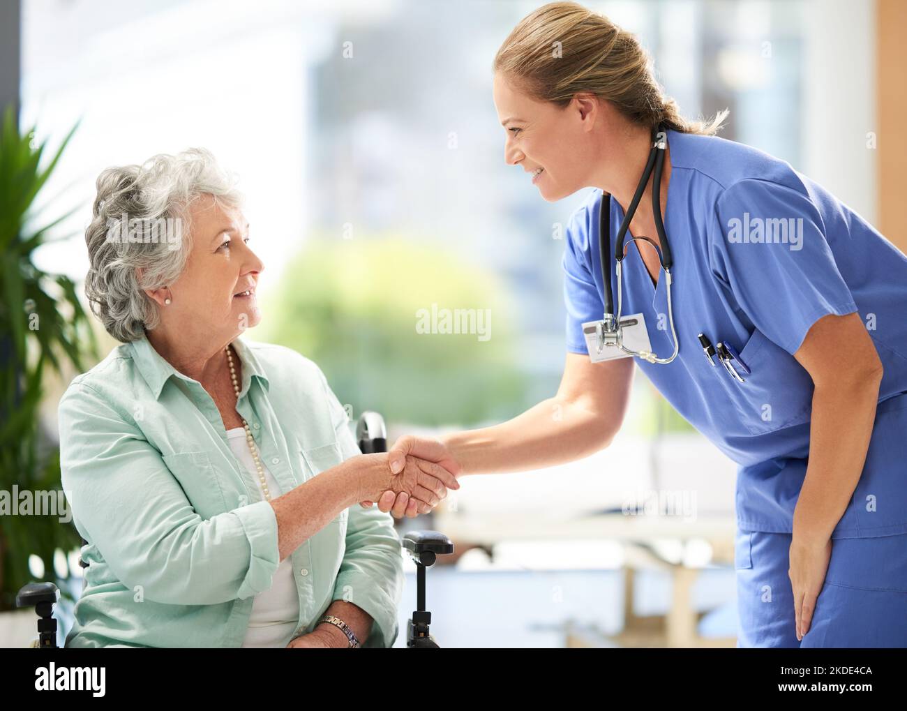 Its great to finally meet you. an attractive female nurse shaking hands ...