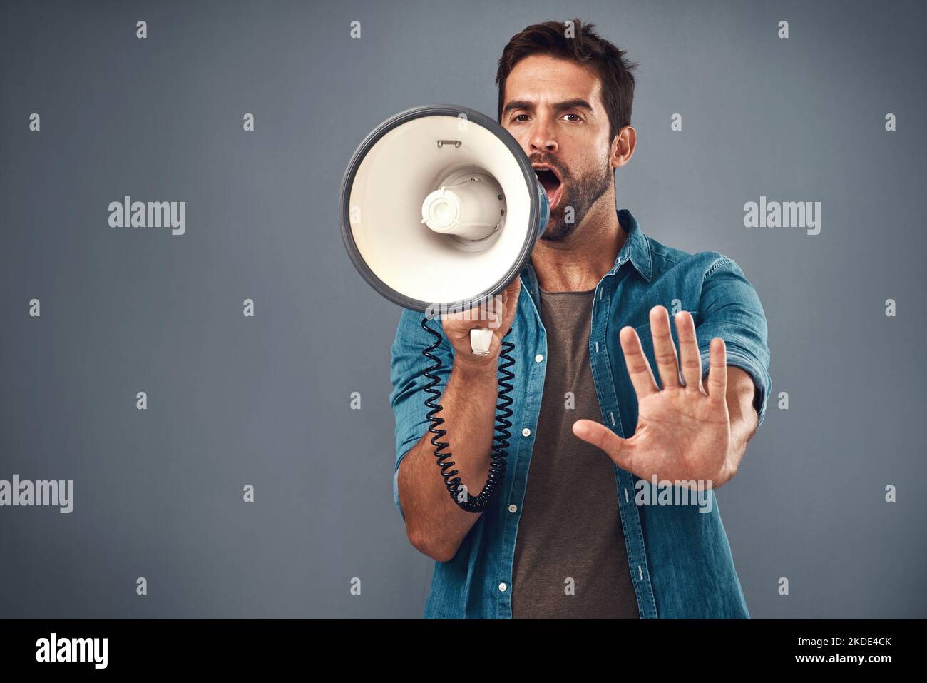 Young man holding megaphone hi-res stock photography and images - Alamy