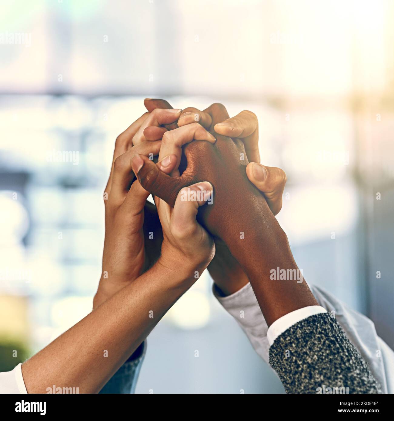 Grab hold of success. a group of unrecognizable businesspeople gripping ...