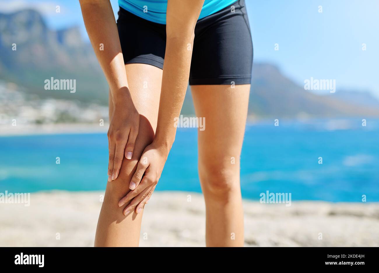 Always remember to stretch. a sporty young woman suffering from a ...