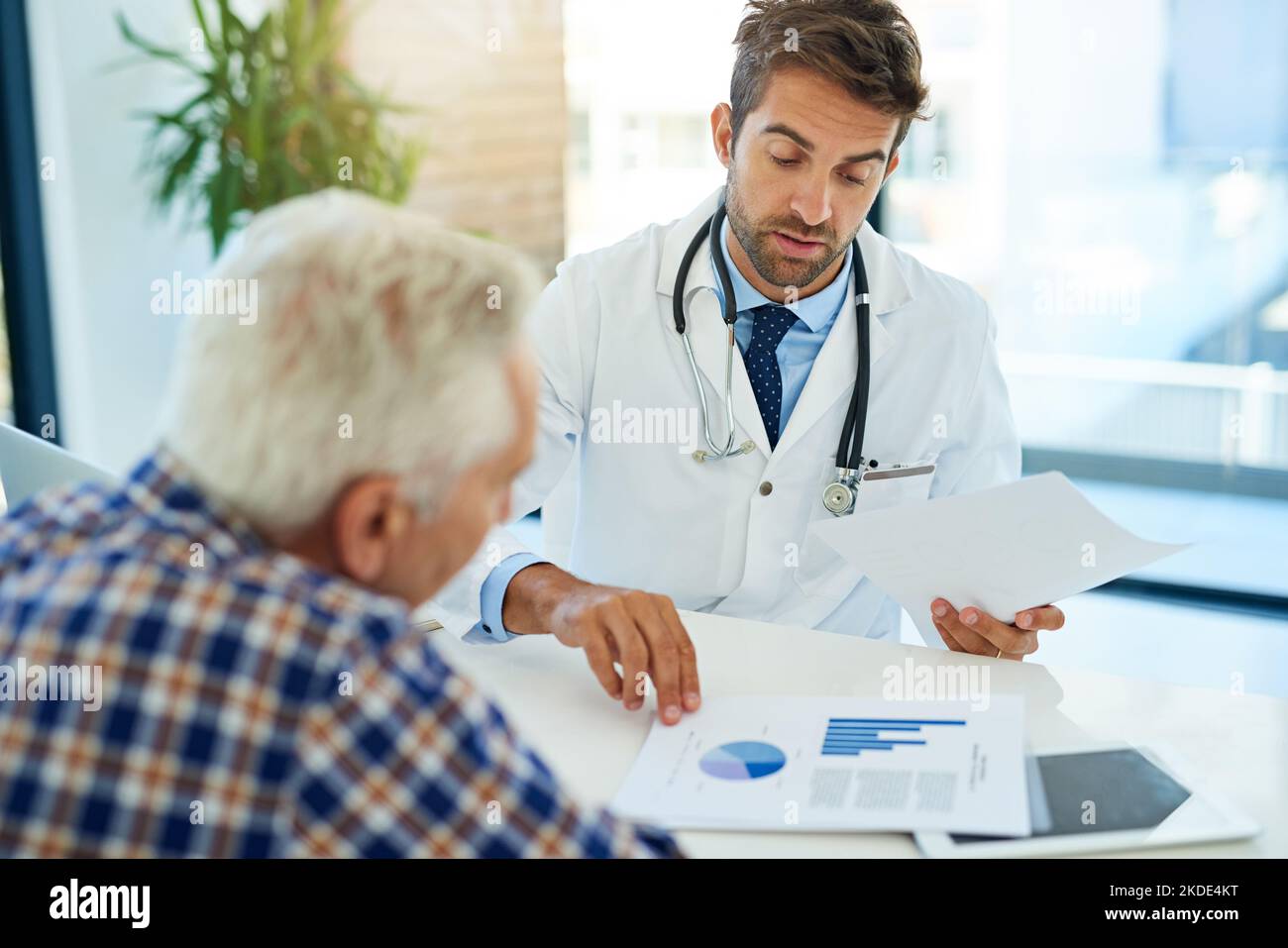 Lets take a look at your medical history together. a doctor consulting ...