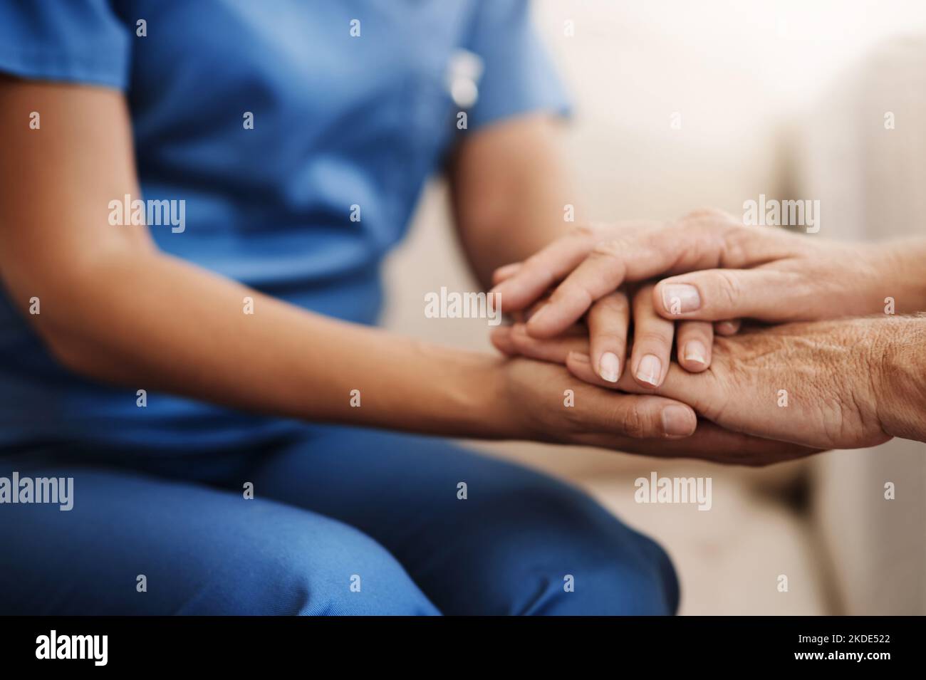 Im here to help. an unrecognizable nurse holding a senior womans hands ...