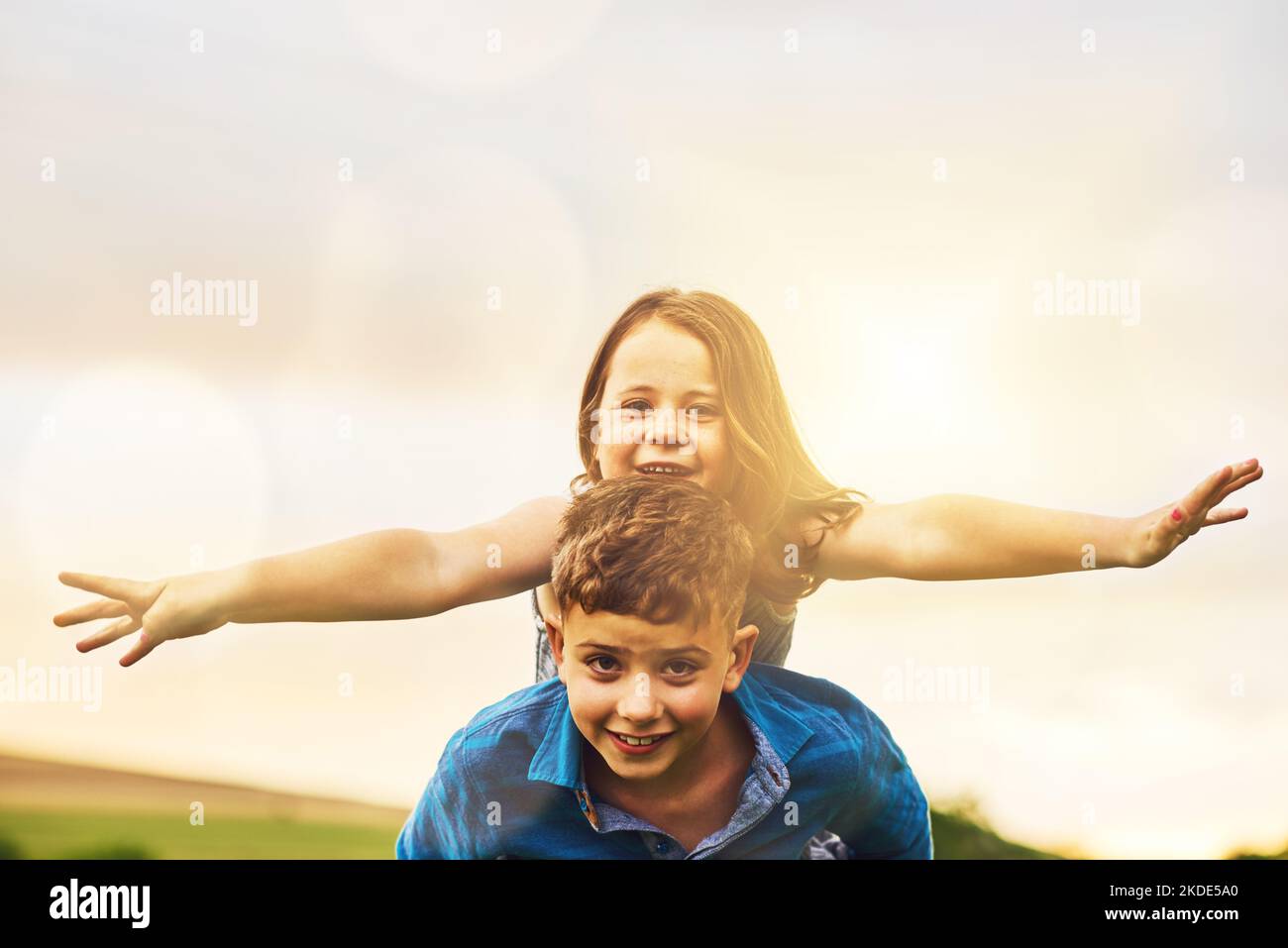 Brothers have strong shoulders for picking up little sisters. Portrait ...