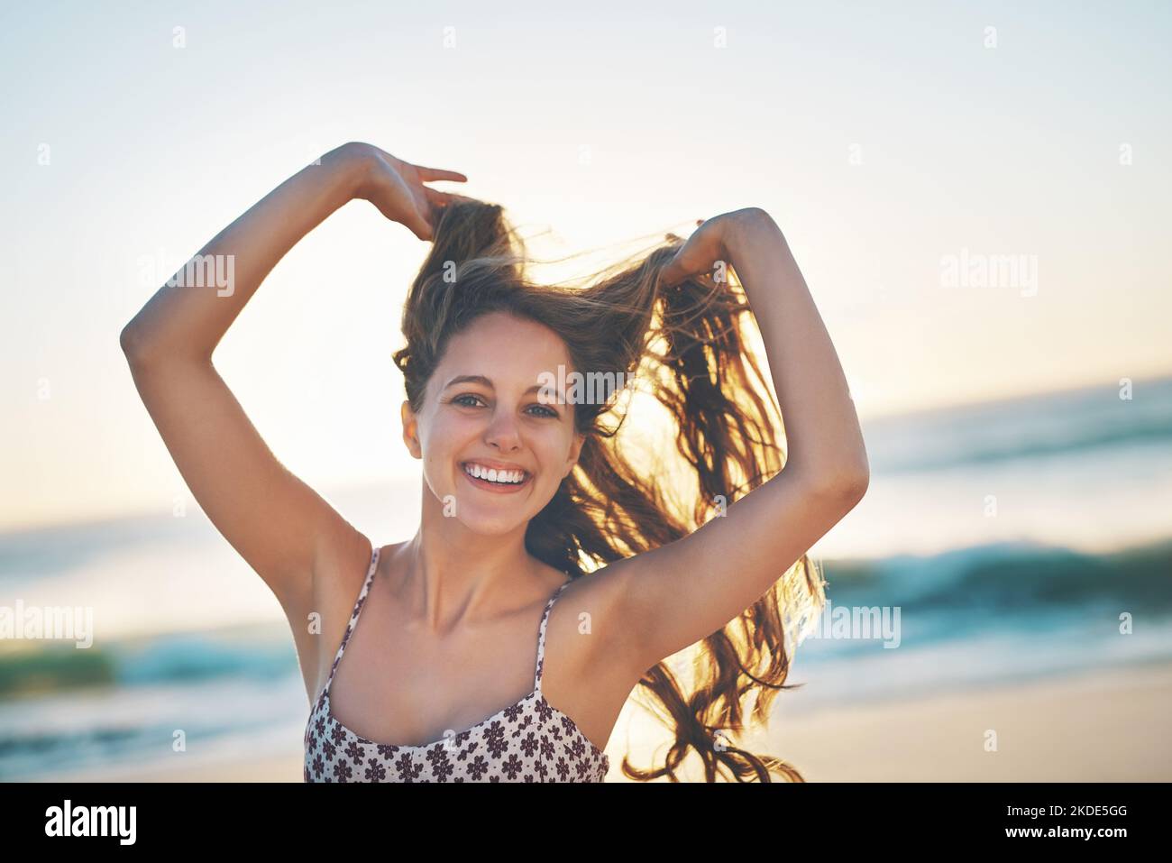 Let the wind play with your hair. a young woman enjoying her day at the ...