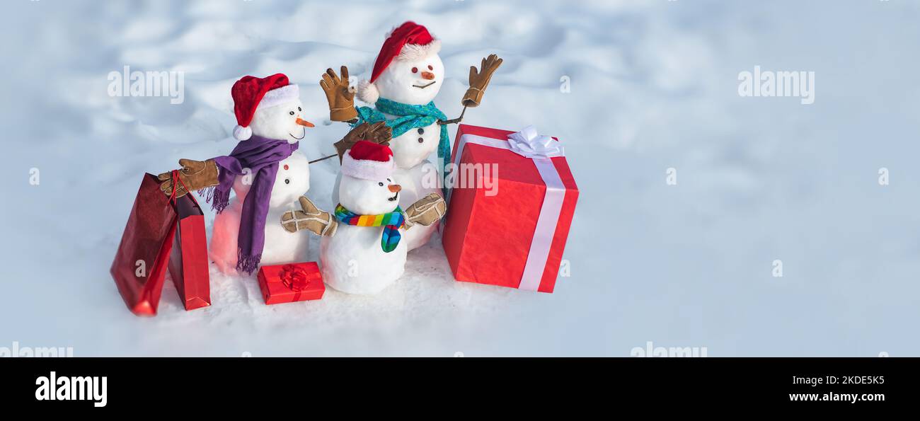 Snowman outdoor. Winter snowman family. Mother, father and child wishes ...